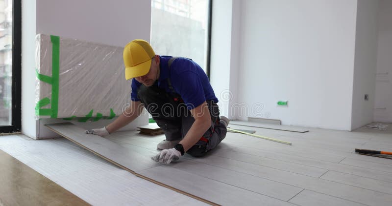 Work of Master on Installation of Floating Floors Laying Laminate on ...