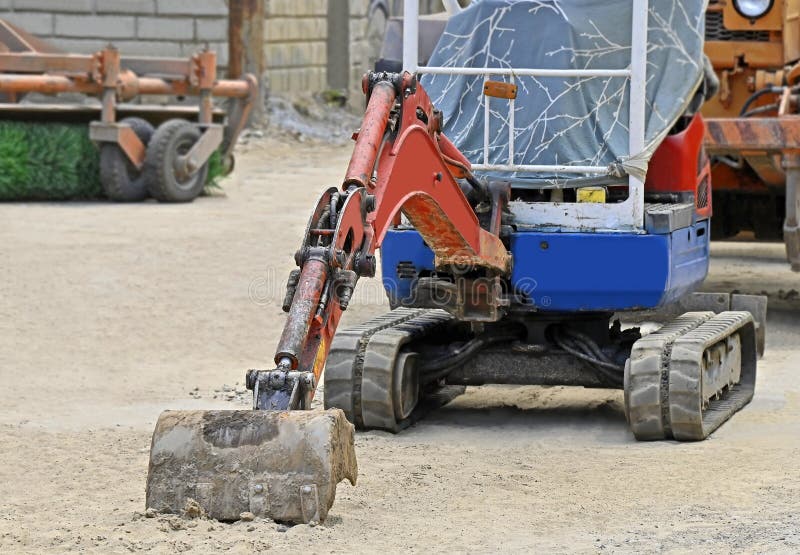Mini excavating machine stock photo. Image of industrial - 318771374