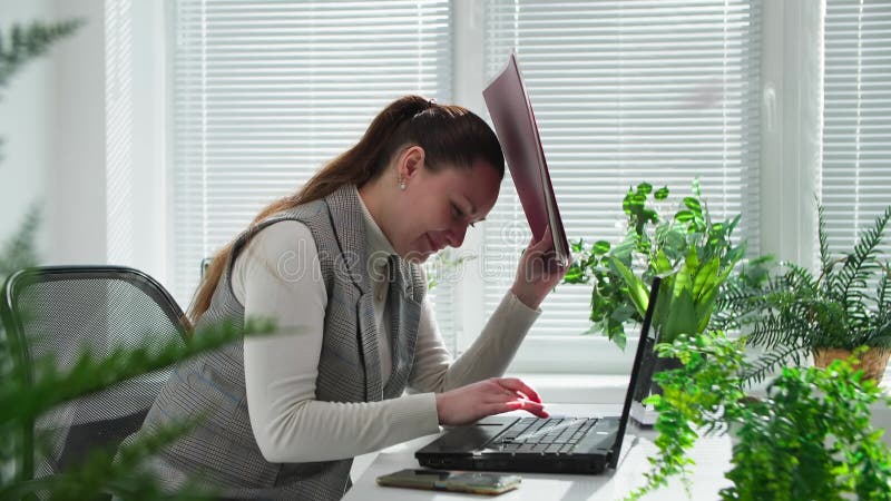 Work Moments in Team, a Young Woman Has Fun Hiding Behind a Folder with ...