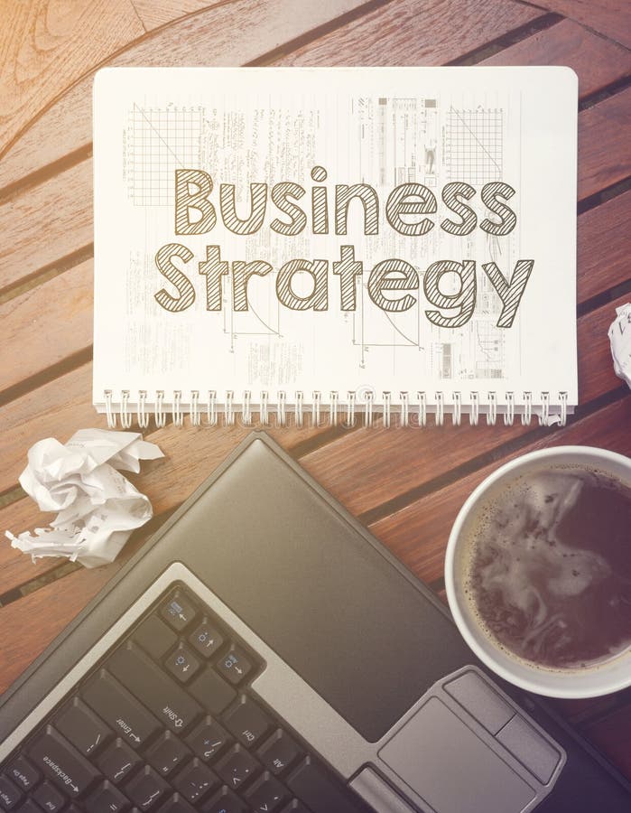 Work Place - Table with Notebook with Note about: Business Strategy ...