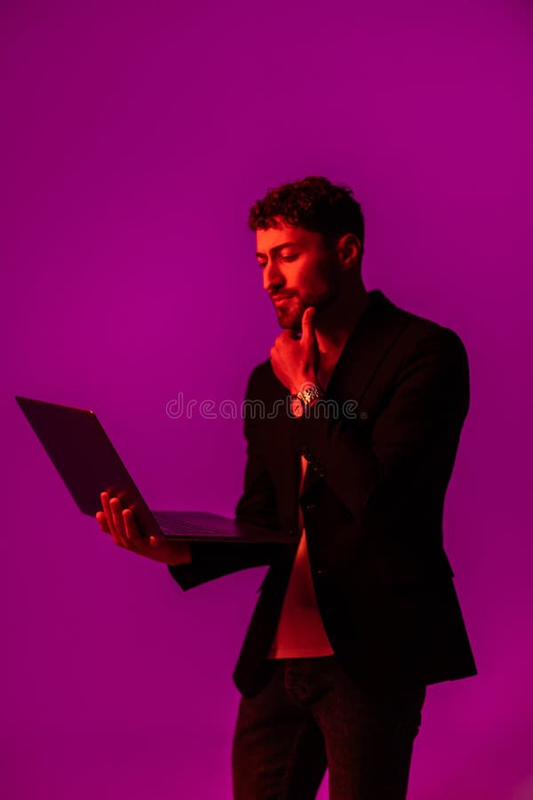 Work and Play Online. Happy Man Holding Laptop and Typing in Neon Light ...