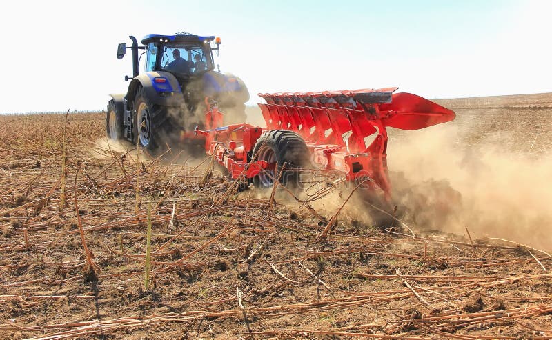 Work of a Powerful Tractor in Field Cultivation and Cultivation. Stock ...