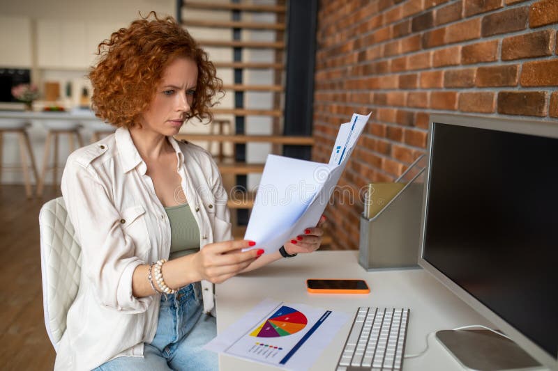 Female Manager Scrutinizing Papers and Looking Involved Stock Photo ...