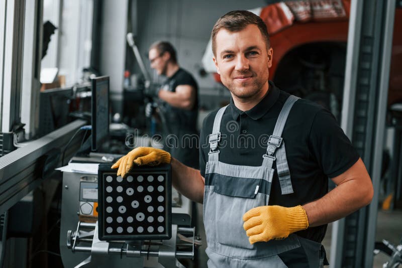 Work in Progress. Man in Uniform is in the Auto Service Stock Image ...