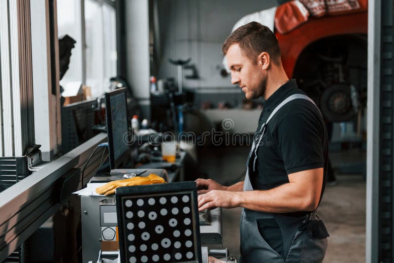 Work in Progress. Man in Uniform is in the Auto Service Stock Photo ...