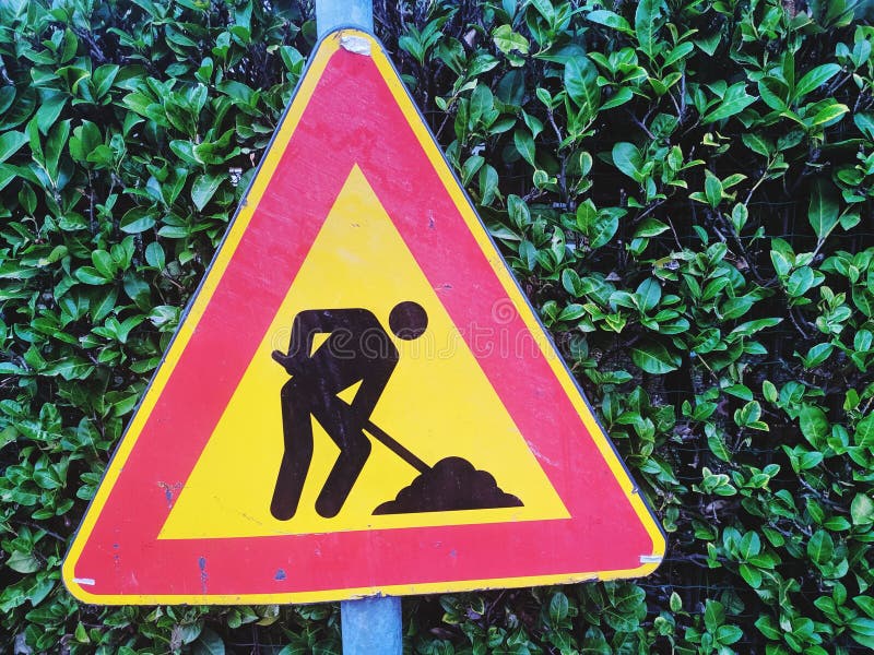 Work in Progress Signal, with Green Leaves Background Stock Photo ...