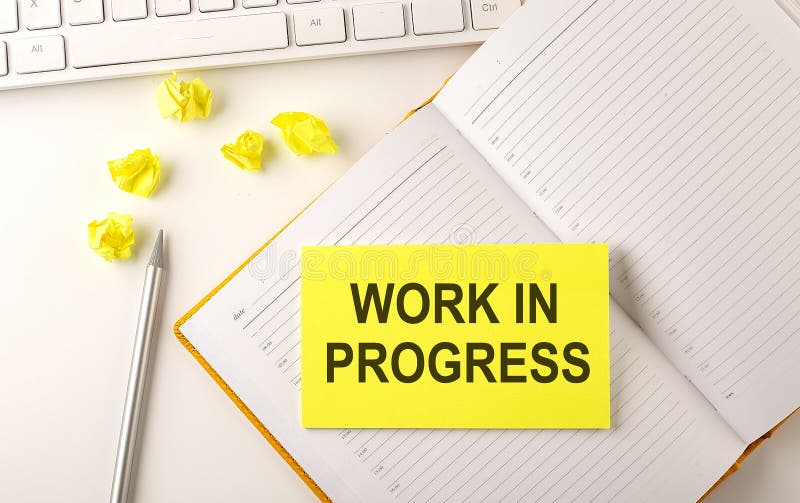 WORK in PROGRESS Text on Sticker on the Diary with Keyboard and Pencil ...