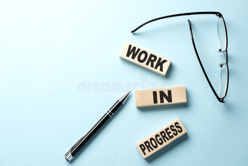 WORK in PROGRESS Text on a Wooden Block ,blue Background Stock Image ...