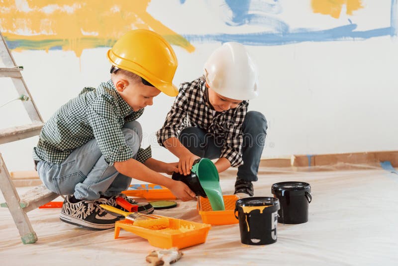 Work in Progress. Two Boys Painting Walls in the Domestic Room Stock ...
