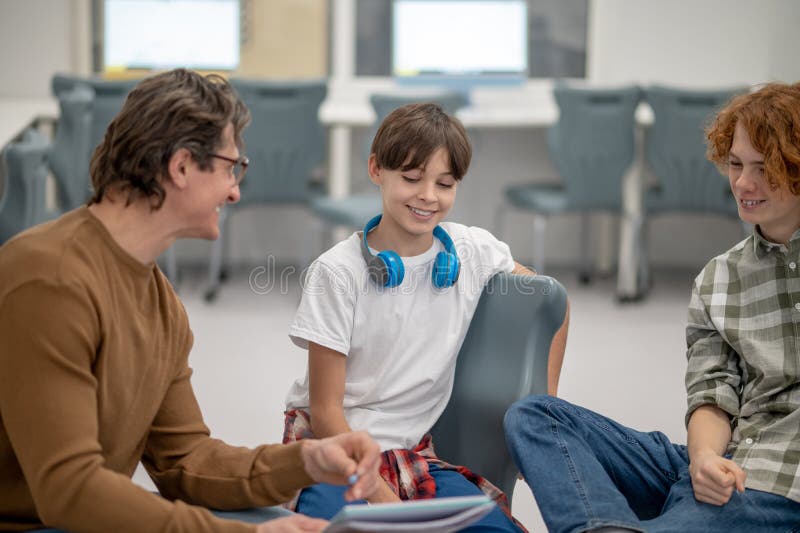Schoolchildren and Their Teacher Working Together on a Project Stock ...