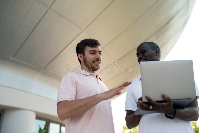 Two Colleagues Discussing Project Details and Looking Interested Stock ...