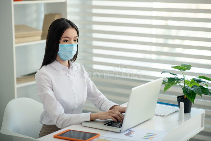 Dark-haired Woman in a Facial Mask Working Stock Image - Image of ...