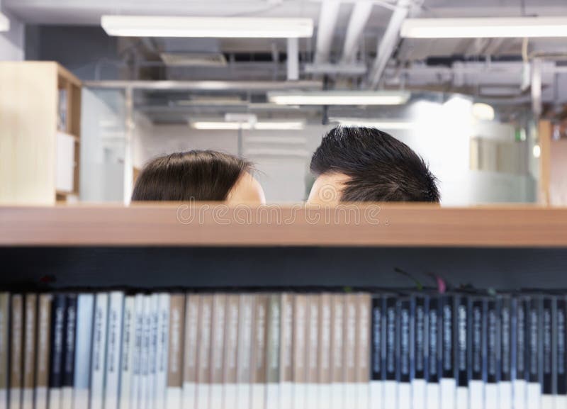 Work Romance between Two Business People Hiding Behind Shelves Stock ...