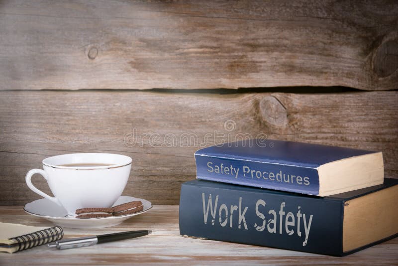 Work Safety and Safety Procedures. Stack of Books on Wooden Desk Stock ...