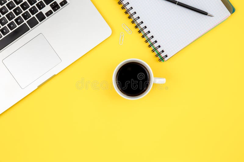 Work Space Layout with Notepad, Laptop and Coffee Cup on a Yellow ...