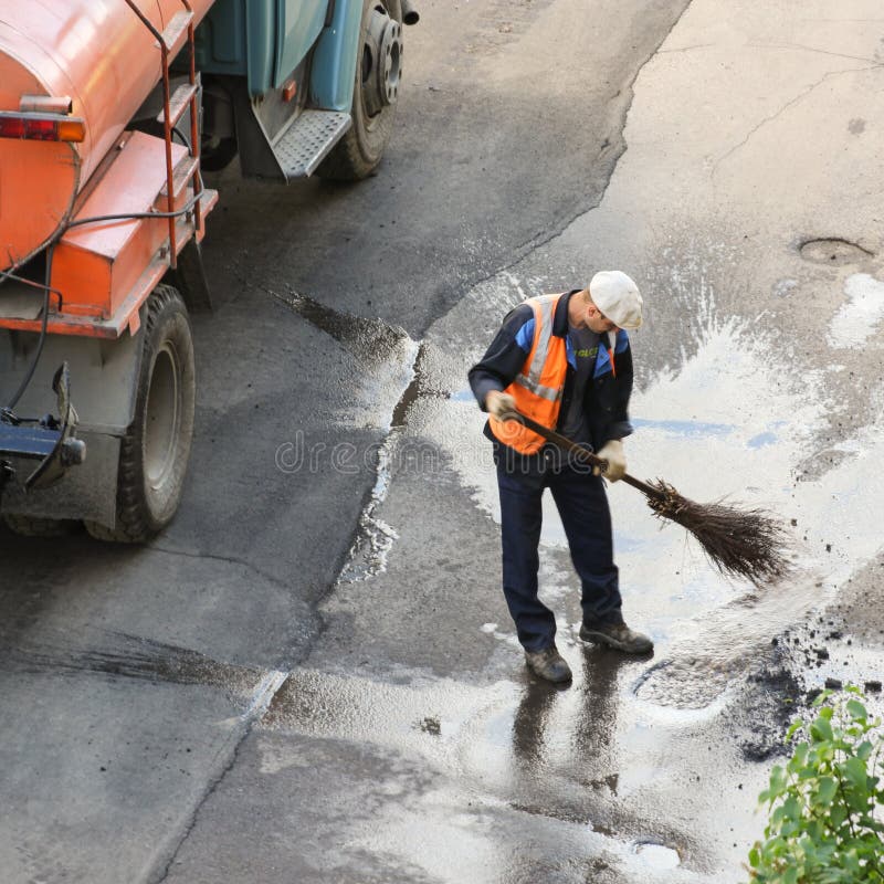 Work Sweeps Puddles on the Road. Editorial Photo - Image of road ...