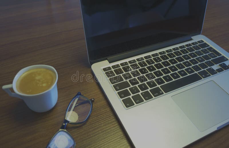Work Table with Laptop, Coffee and a Glasses. Editorial Photography ...