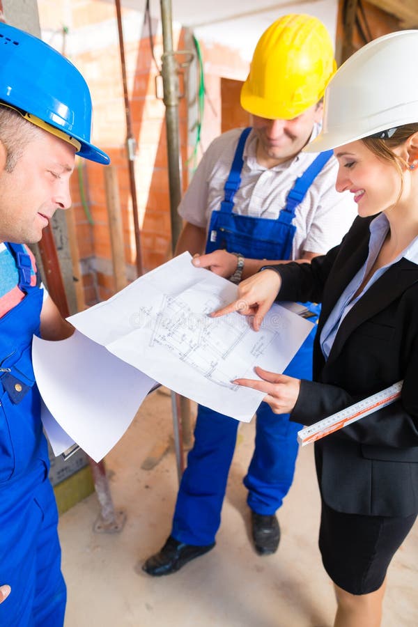 Work Team on Construction Site Controlling Floor Plan Stock Photo ...