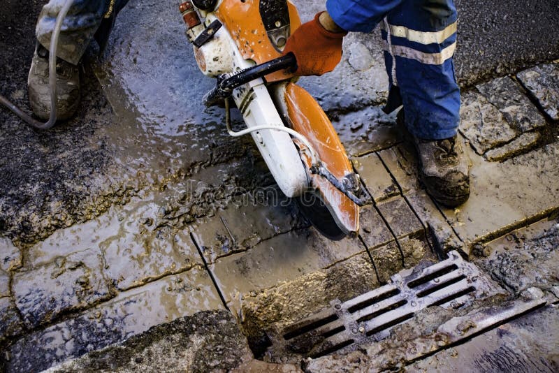 Work To Update the Road Coverage.a Circular Saw Cuts the Pavement Slabs ...