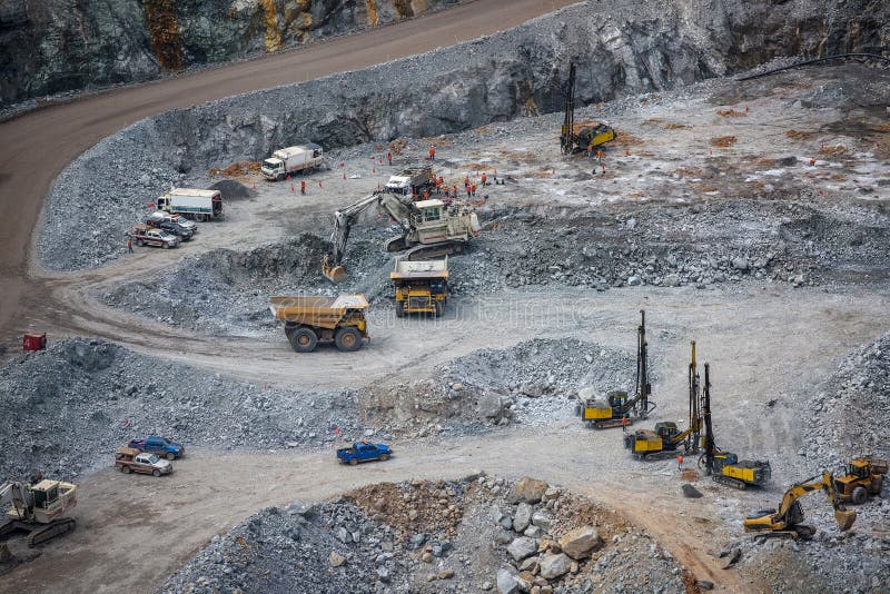 Work of Trucks and the Excavator in an Open Pit on Gold Mining Stock ...
