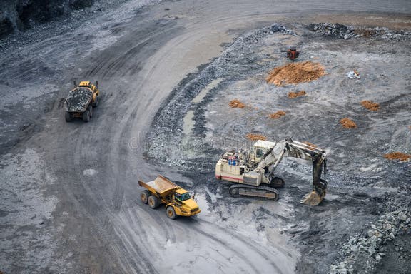 Work of Trucks and the Excavator in an Open Pit on Gold Mining Stock ...