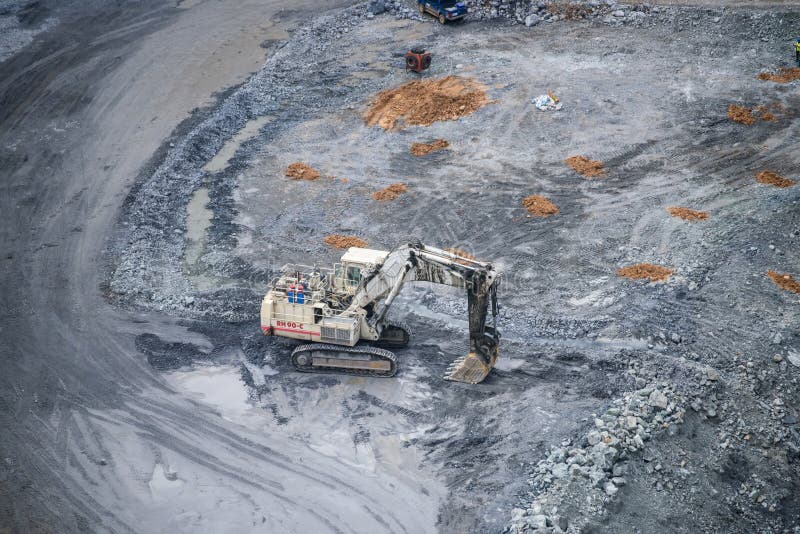 Work of Trucks and the Excavator in an Open Pit on Gold Mining Stock ...