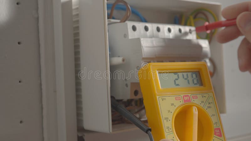 Work Under Voltage, Electrician is Checking Serviceability of Equipment ...