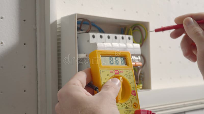 Work Under Voltage, Electrician is Checking Serviceability of Equipment ...