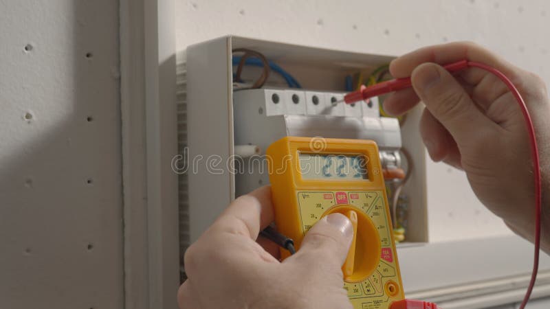 Work Under Voltage, Electrician is Checking Serviceability of Equipment ...