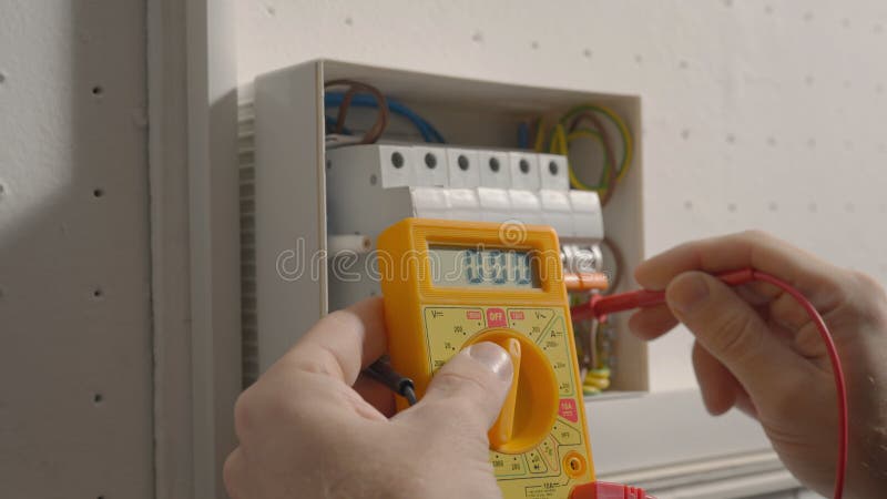 Work Under Voltage, Electrician is Checking Serviceability of Equipment ...