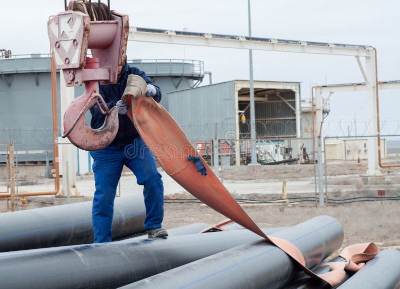 Work on Unloading of Pipes for Construction. Stock Image - Image of ...