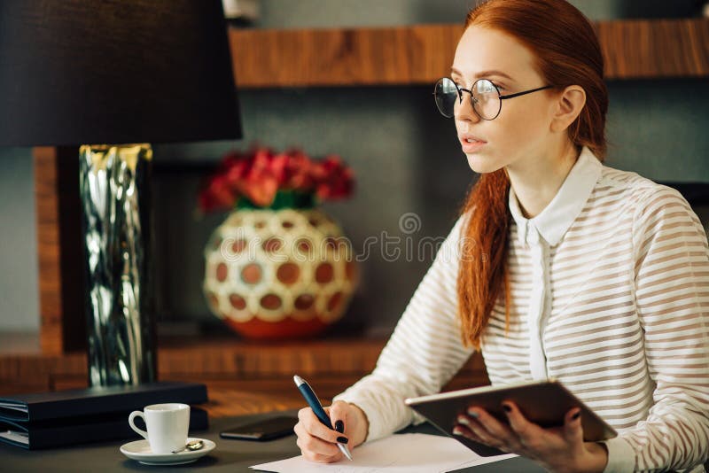 Woman Writing on Paper with Digital Tablet Computer in Office Room ...
