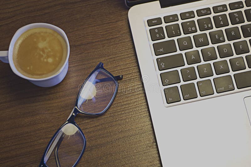 Work Table with Laptop, Coffee and a Glasses. Editorial Photography ...