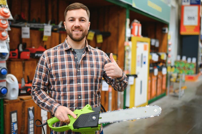 Worke Holds Electric Saw in Tool Store Stock Photo - Image of service ...