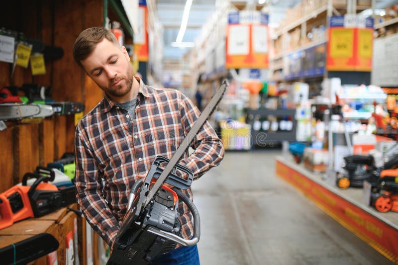Worke Holds Electric Saw in Tool Store Stock Image - Image of choosing ...