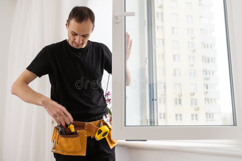 Worker Adjusting Installed Window with Screwdriver Indoors, Closeup ...