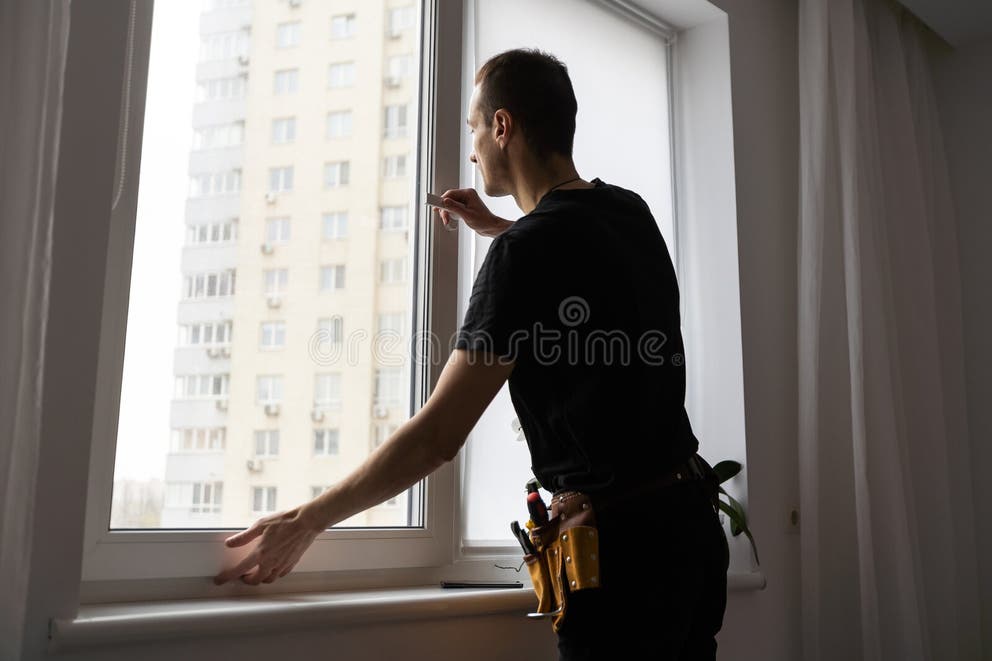 Worker Adjusting Installed Window with Screwdriver Indoors, Closeup ...