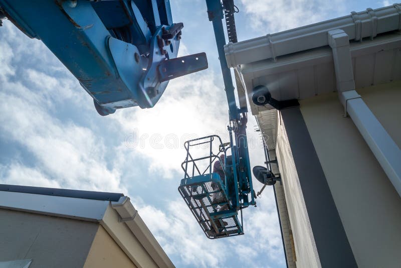 Worker on a Aerial Access Platform, Cherry Picker, Cleaning House Stock ...