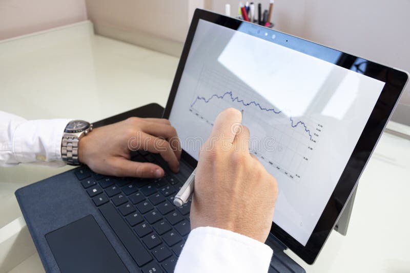 Worker Analyzing Statistics on a Laptop in the Office Editorial Photo ...