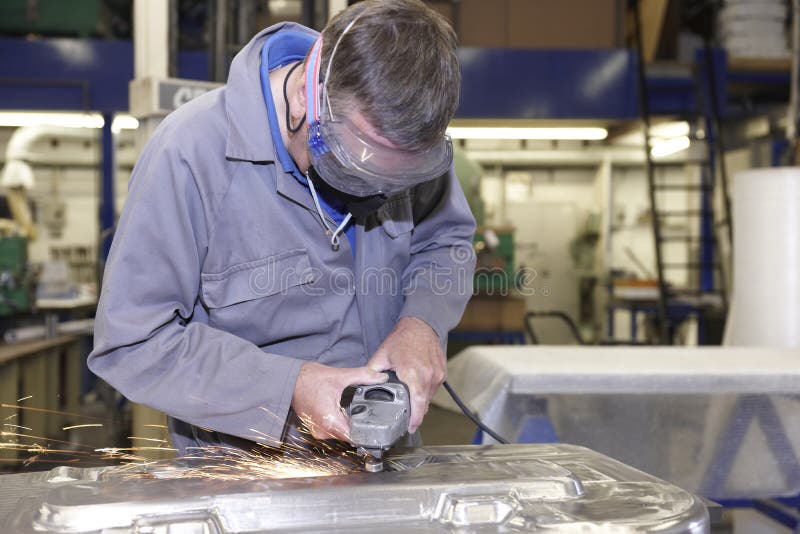 Worker with angle grinder stock photo. Image of workshop - 14217454