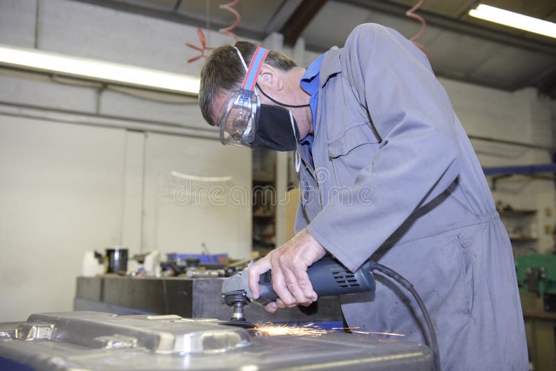 Worker with angle grinder stock photo. Image of craftsman - 14217676