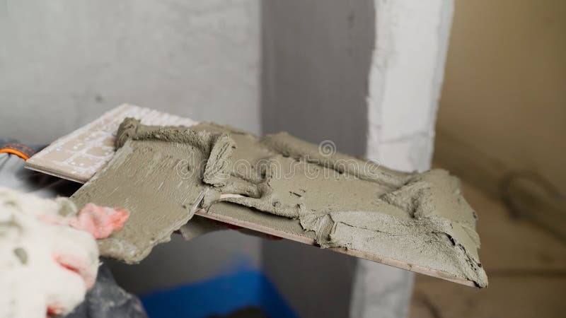 Applying Thinset Mortar on a Tile. Apply the Adhesive, Closeup. a ...