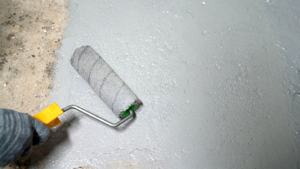 Worker Applying Epoxy Resin with Paint Roller on Concrete Floor Stock ...