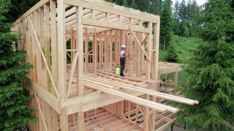 Worker Applying Fire Retardant Using Sprayer, while Constructing Wooden ...