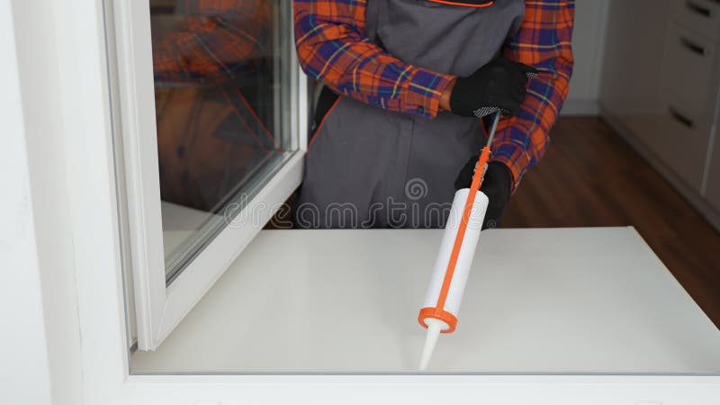 A Worker is Applying Polyurethane Foam To Fill Gap between Sash and ...