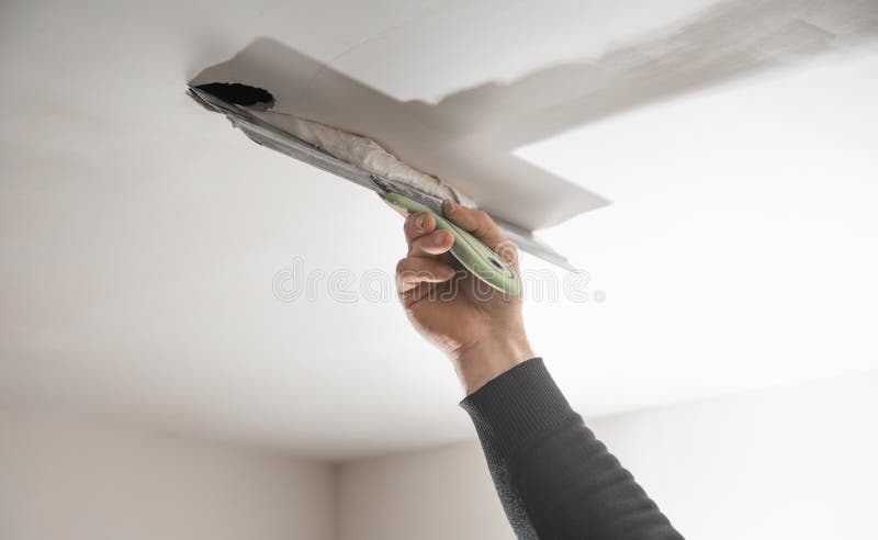 Worker is Applying Putty on a Ceiling. Renovating House Stock Photo ...