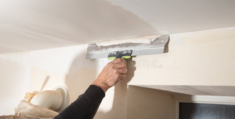 Worker is Applying Putty on a Ceiling. Renovating House Stock Photo ...