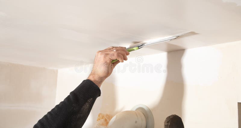 Worker is Applying Putty on a Ceiling. Renovating House Stock Image ...