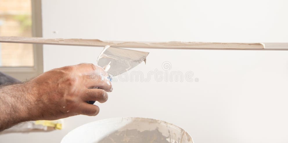 Worker Applying Putty on Material. Renovating Home Stock Photo - Image ...