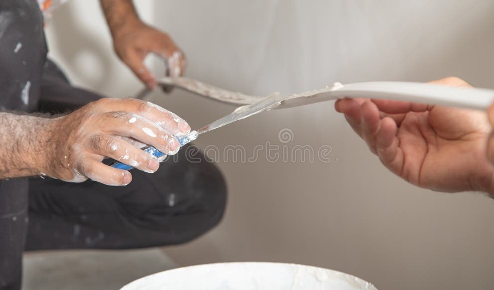 Worker Applying Putty on Material. Renovating Home Stock Photo - Image ...